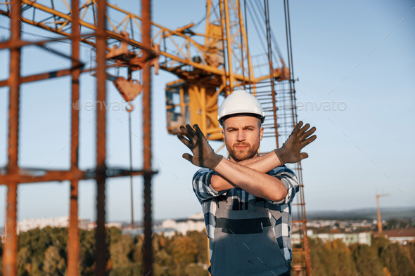 Restricted area. No trespassing. Man is working on the construction ...
