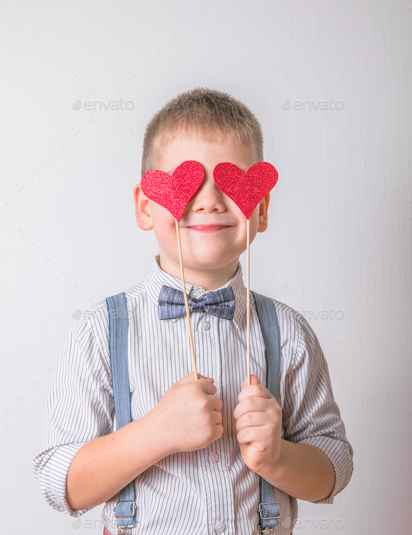 smiling boy holding a red heart on eays symbol of love Backgrounds for ...