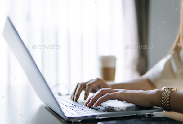 Close up hand use computer laptop, people tapping on keyboard of laptop ...