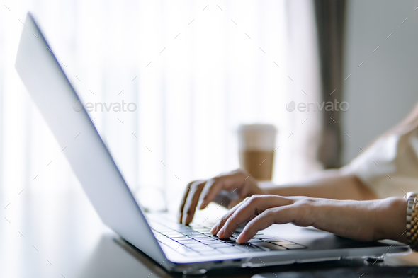 Close up hand use computer laptop, people tapping on keyboard of laptop ...