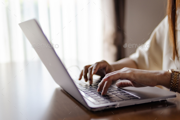 Close up hand use computer laptop, people tapping on keyboard of laptop ...