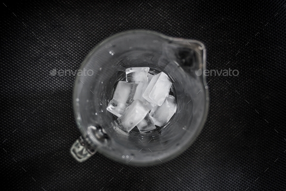 Grayscale overhead selective closeup shot of ice cubes inside of a ...