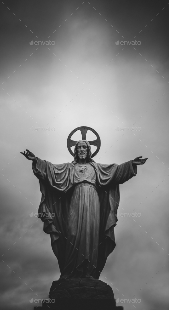 Vertical shot of a statue of the Vietnamese Jesus in black and white ...