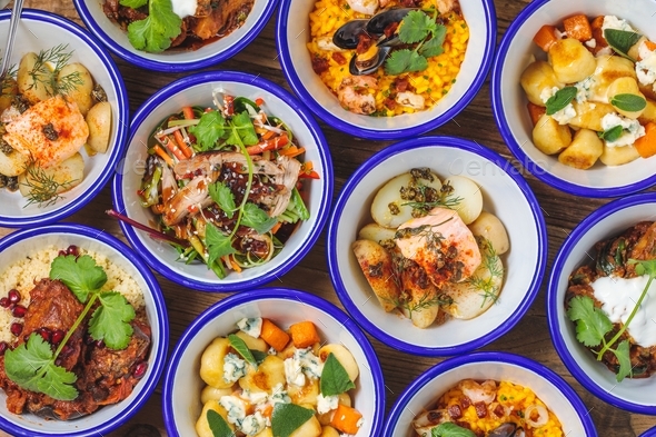 Overhead shot of different types of dishes in bowls near each other on ...
