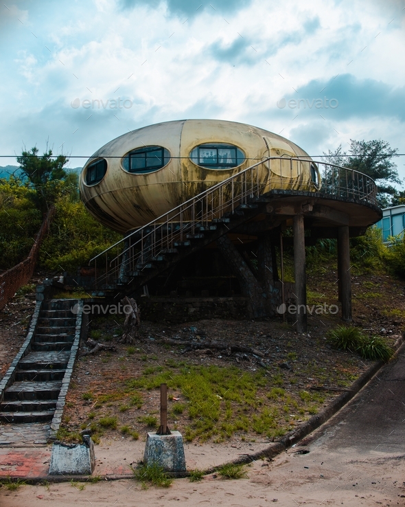 Abandoned rusty UFO house with concrete stairs under the cloudy sky in ...