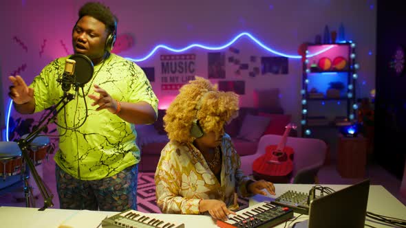 Black Singer Recording Song with Female Sound Engineer, Stock Footage