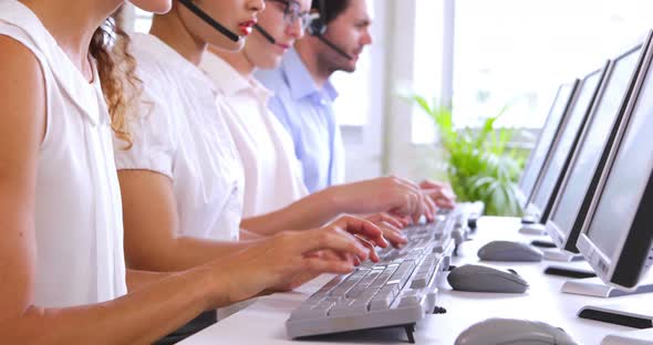 Row of Call Center Agents Typing at their Desk, Stock Footage | VideoHive