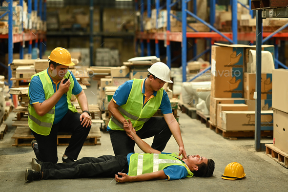 Shot of warehouse workers are helping and giving the injured first aid ...