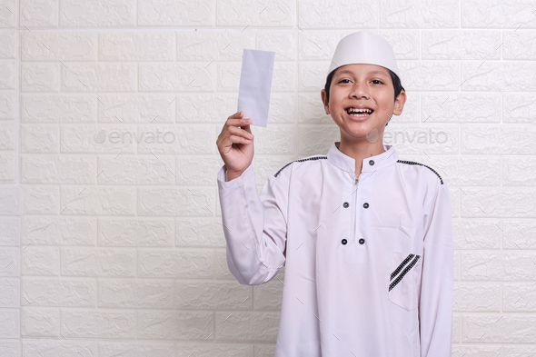 Cheerful muslim kid showing envelope, eid gift Stock Photo by ...