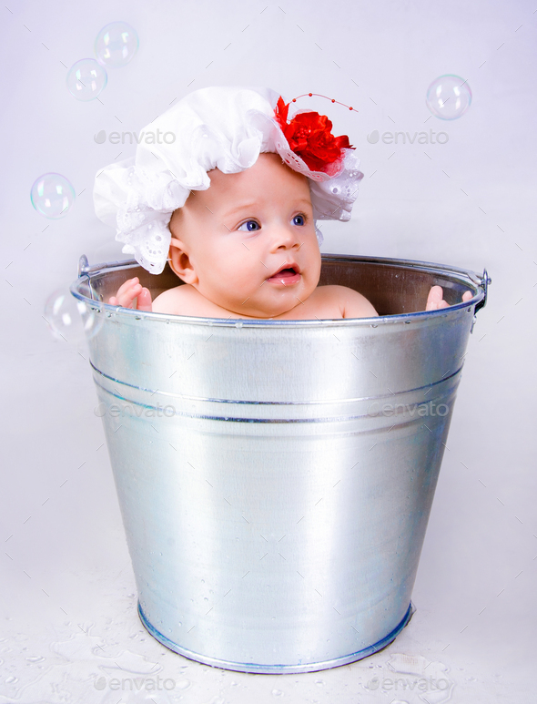 baby on a bucket Stock Photo by tan4ikk | PhotoDune