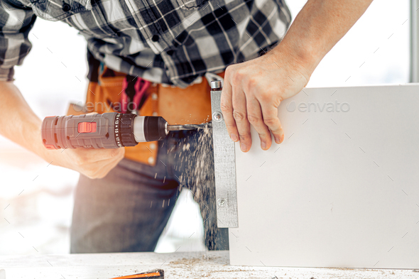 Man working during process of furniture manufacturing Stock Photo by ...
