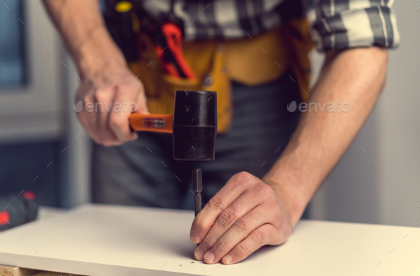 Man working during process of furniture manufacturing Stock Photo by ...
