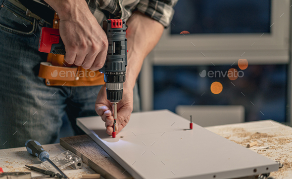 Man working during process of furniture manufacturing Stock Photo by ...