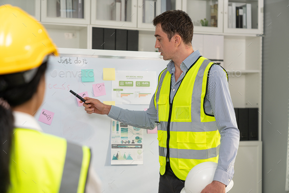 Engineer man presentation project and strategy plan on whiteboard at ...