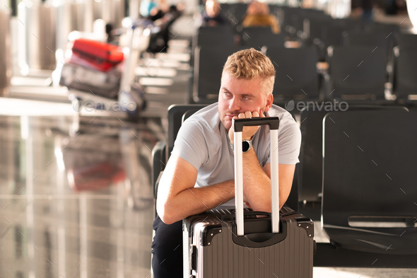 Handsome bored tired unhappy caucasian passenger, man sitting with ...