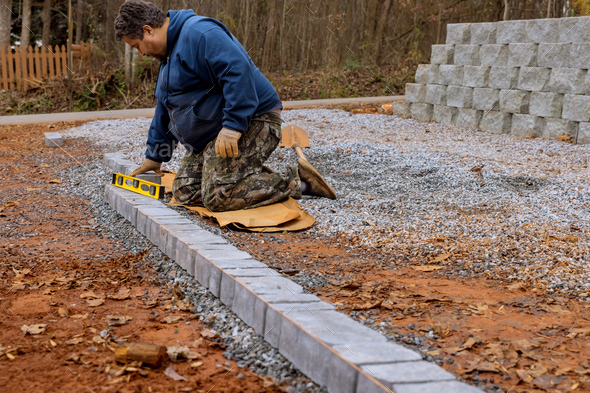 The construction worker is installing and arranging the precast ...