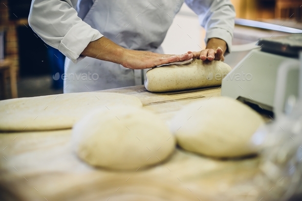 Shallow focus shot of the cook working with the raw dough Stock Photo ...