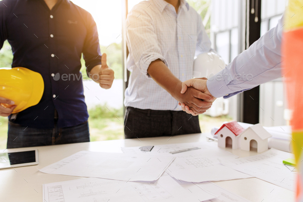 Engineers handshake at meeting. Congratulations and agreed to do the ...