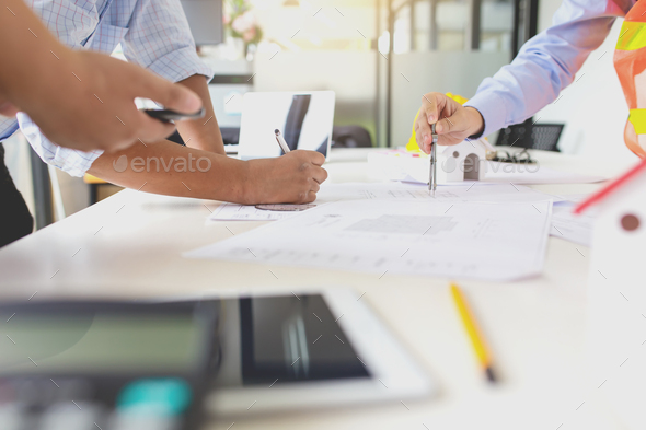 Businessman, construction project owner and engineer planning and ...