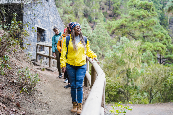 Multiracial women having fun exploring nature on trekking day in ...