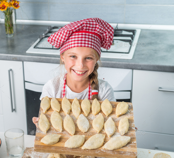 little girl with raw patties on board Stock Photo by tan4ikk | PhotoDune