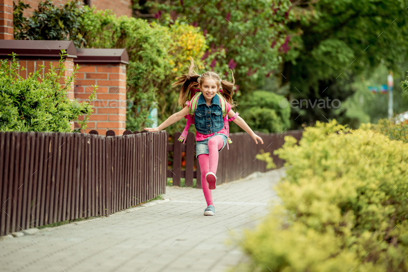 little girl run from school Stock Photo by tan4ikk | PhotoDune