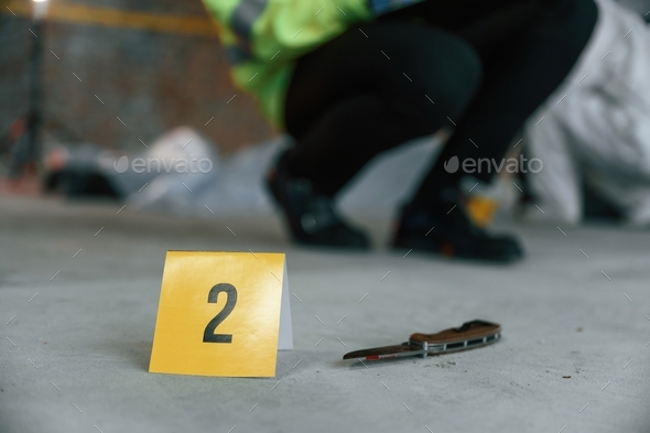 Detectives are collecting evidence in a crime scene near dead body ...