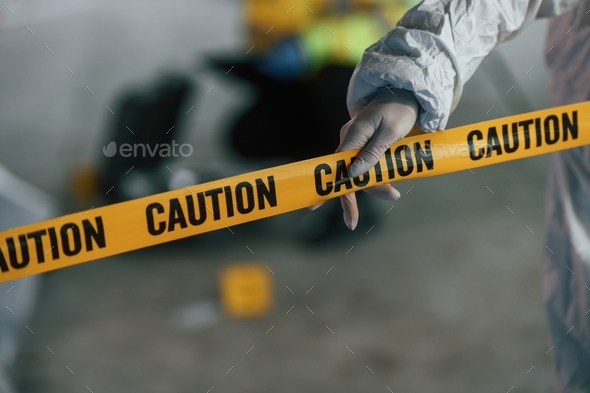 caution police tape. Detectives are collecting evidence in a crime ...