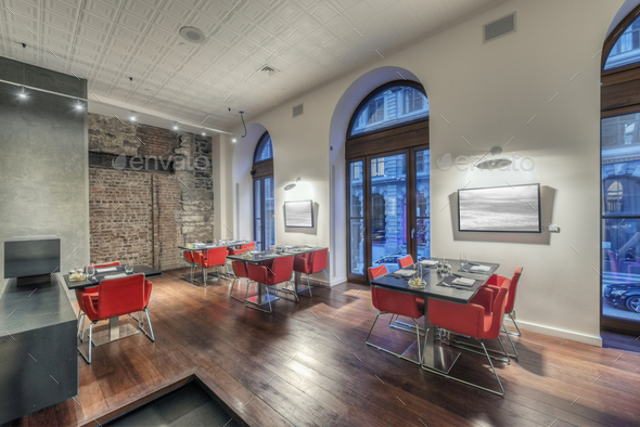 Modern restaurant interior with red chairs. Stock Photo by Mint_Images