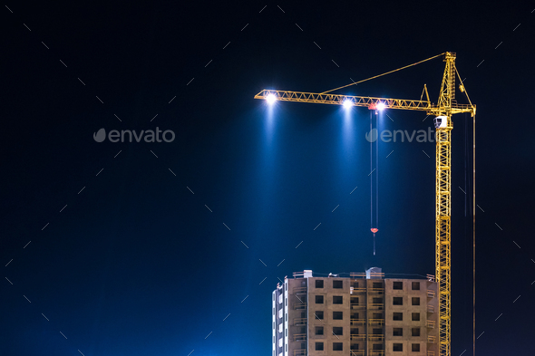 Tower cranes and unfinished multi-storey high near buildings under ...
