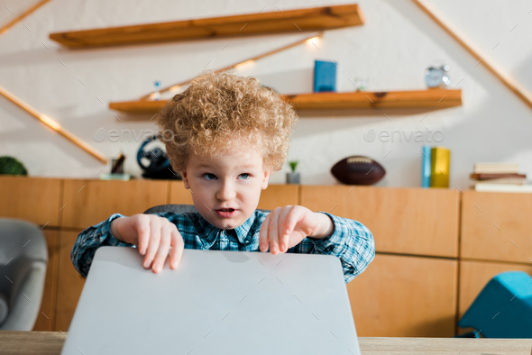 adorable and smart child touching laptop while studying at home Stock ...