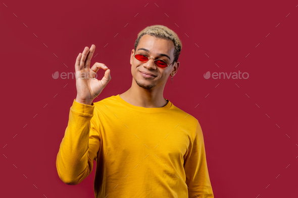 Positive man makes OK hand sign, okay gesture. Happy student guy in ...