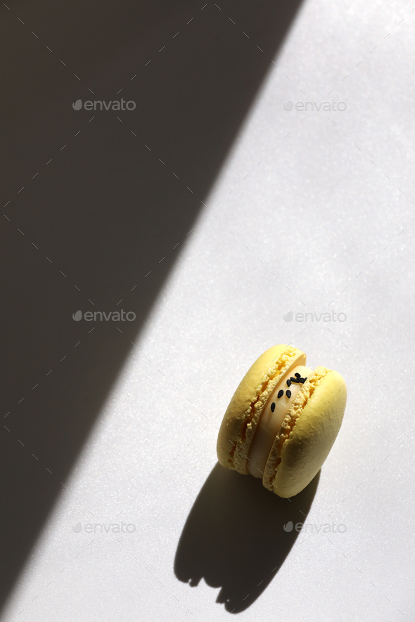 Sweet yellow lemon french macaroon or macaron dessert isolated on white ...
