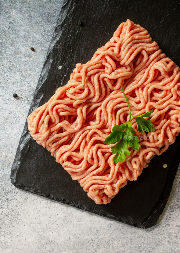 Fresh Raw mince. Ground Minced beef on stone slate blackboard. Top view ...