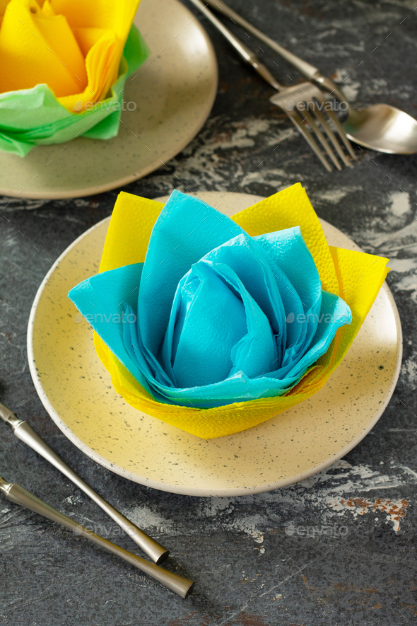 Table setting with colored paper napkins on stone background. Stock ...