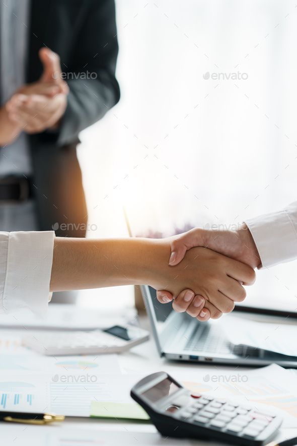 Business success. Business people shake hand to confirm the agreement ...