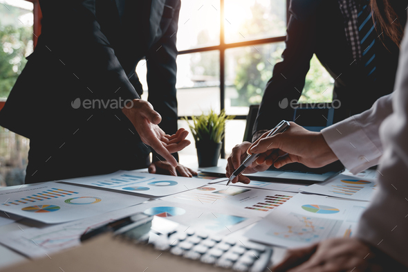 Group of business people meeting to plan, analyze, graph and chart ...
