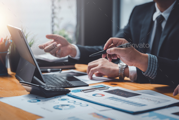 Business people meeting explaining the financial graph data and ...