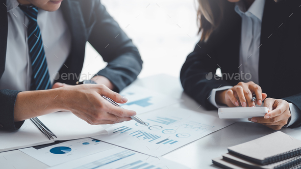 Business people using a calculator Think analyzing income, financial ...