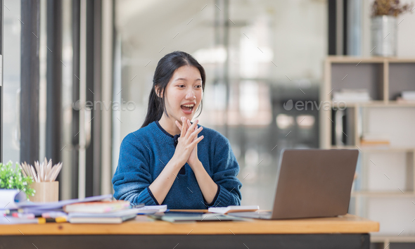 Image of a happy excited young entrepreneur Asian woman in workplace ...