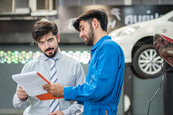 Car mechanic explain car damage condition to customer at the auto ...