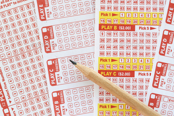 Flat lay of lottery ticket sheets with numbers and pencil - lottery ...