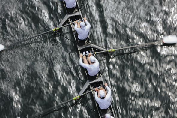Overhead view of female crew racers rowing in an octuple racing shell ...
