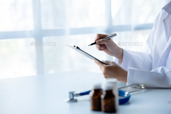 Doctors looking at patient's diagnostic documentation in the hospital's ...