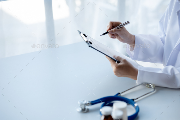 Doctors looking at patient's diagnostic documentation in the hospital's ...