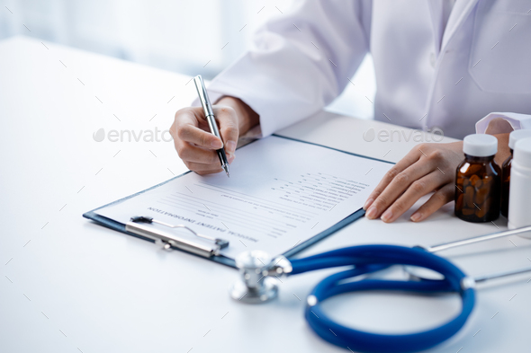 Doctors looking at patient's diagnostic documentation in the hospital's ...