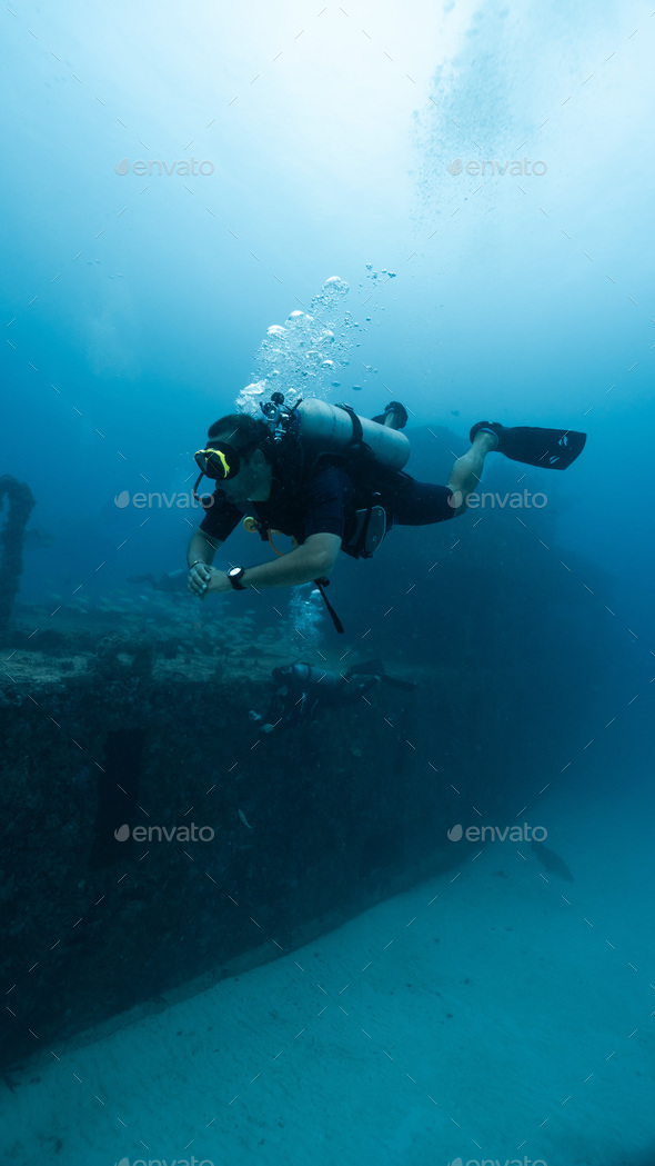 male diver posing in front of a sunken ship, technical diving Stock ...