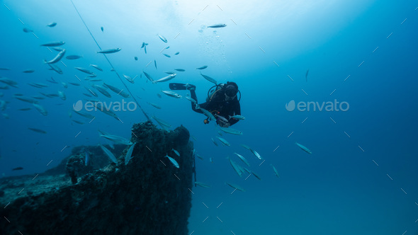 female diver posing in front of a sunken ship, technical diving Stock ...