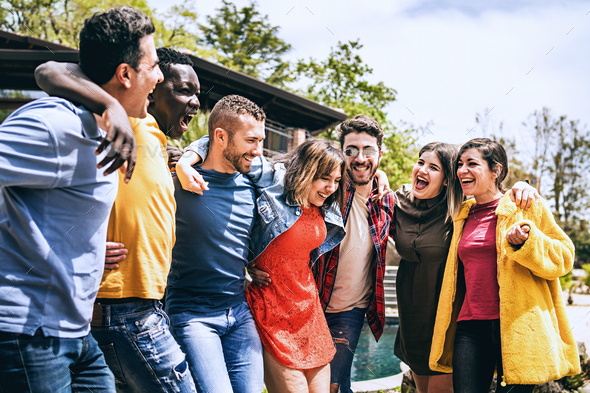 Group of diverse friends having a laugh in a park Stock Photo by baffos