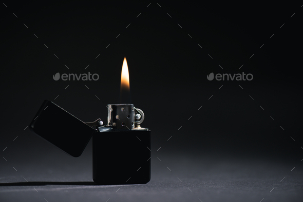 lighter with burning fire on black with copy space Stock Photo by ...